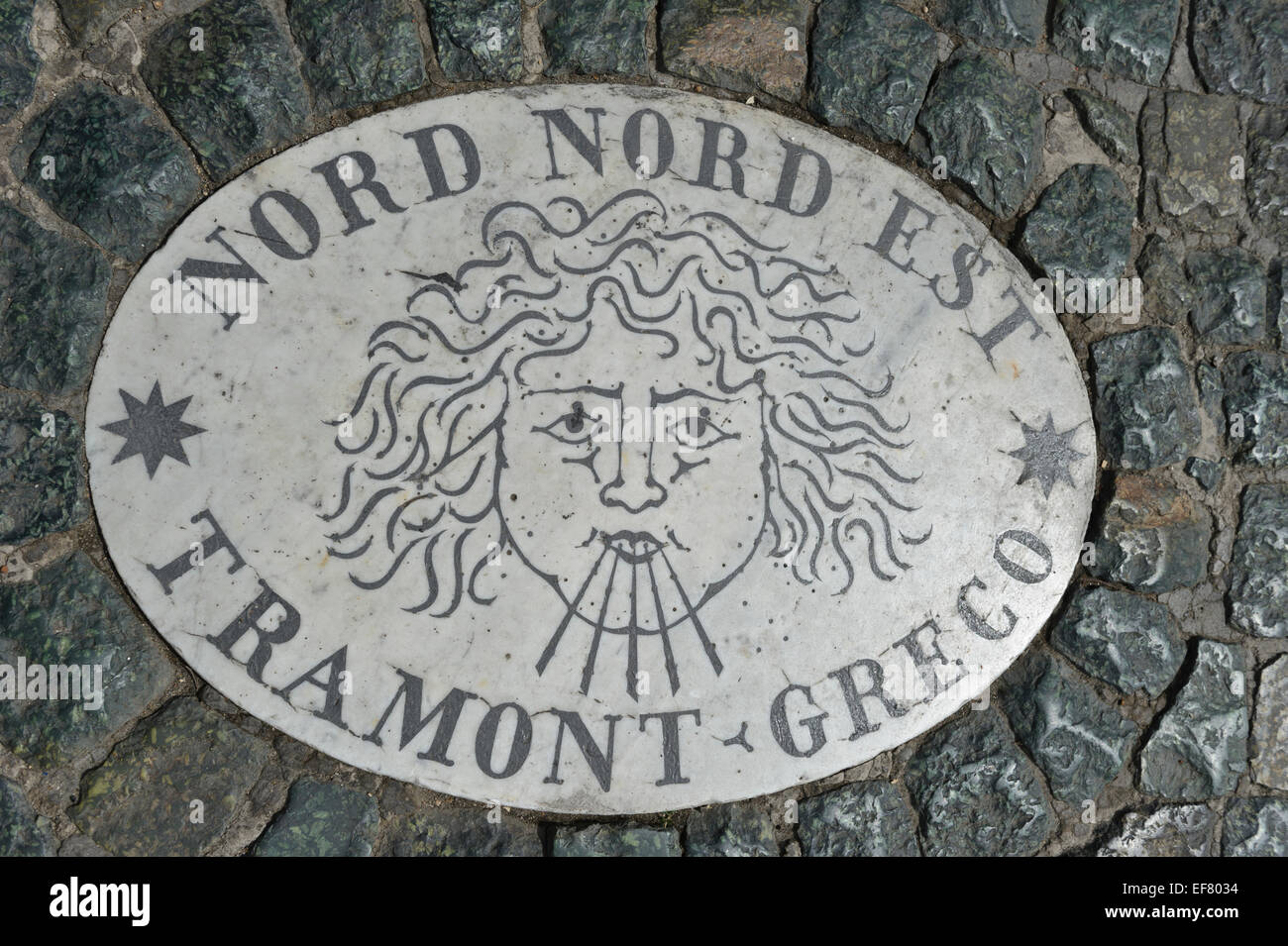 A circular plaque of wind direction embedded in the pavement in St ...