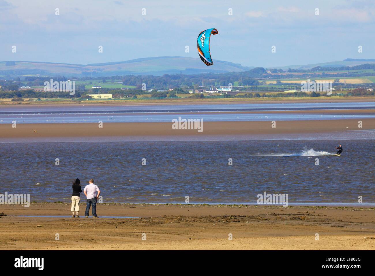 Couple watching Kitesurfing. Solway Coast, Cumbria, England, United ...