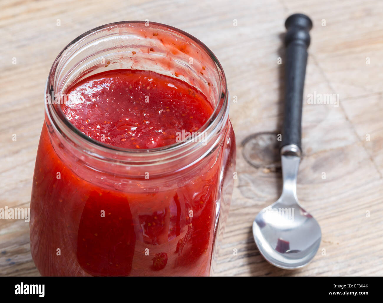 Strawberry jam in a jar on wood Stock Photo - Alamy