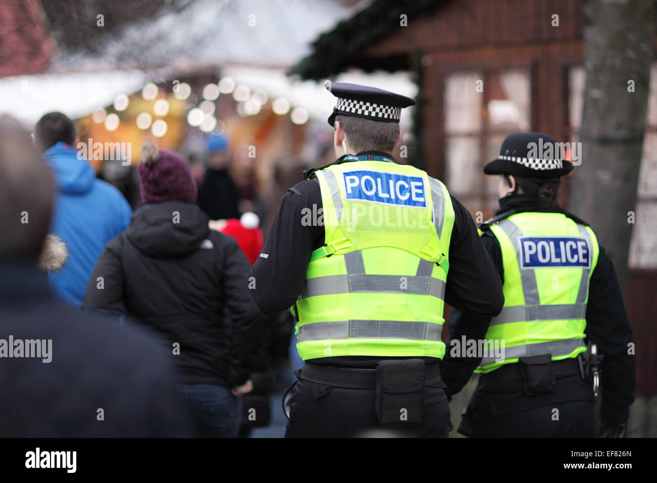 Police in hi-visibility jackets policing crowd control at a UK event ...