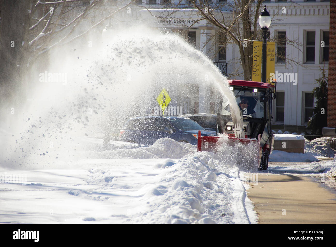 Snowblower clearing snow on a college campus after a big snow storm ...