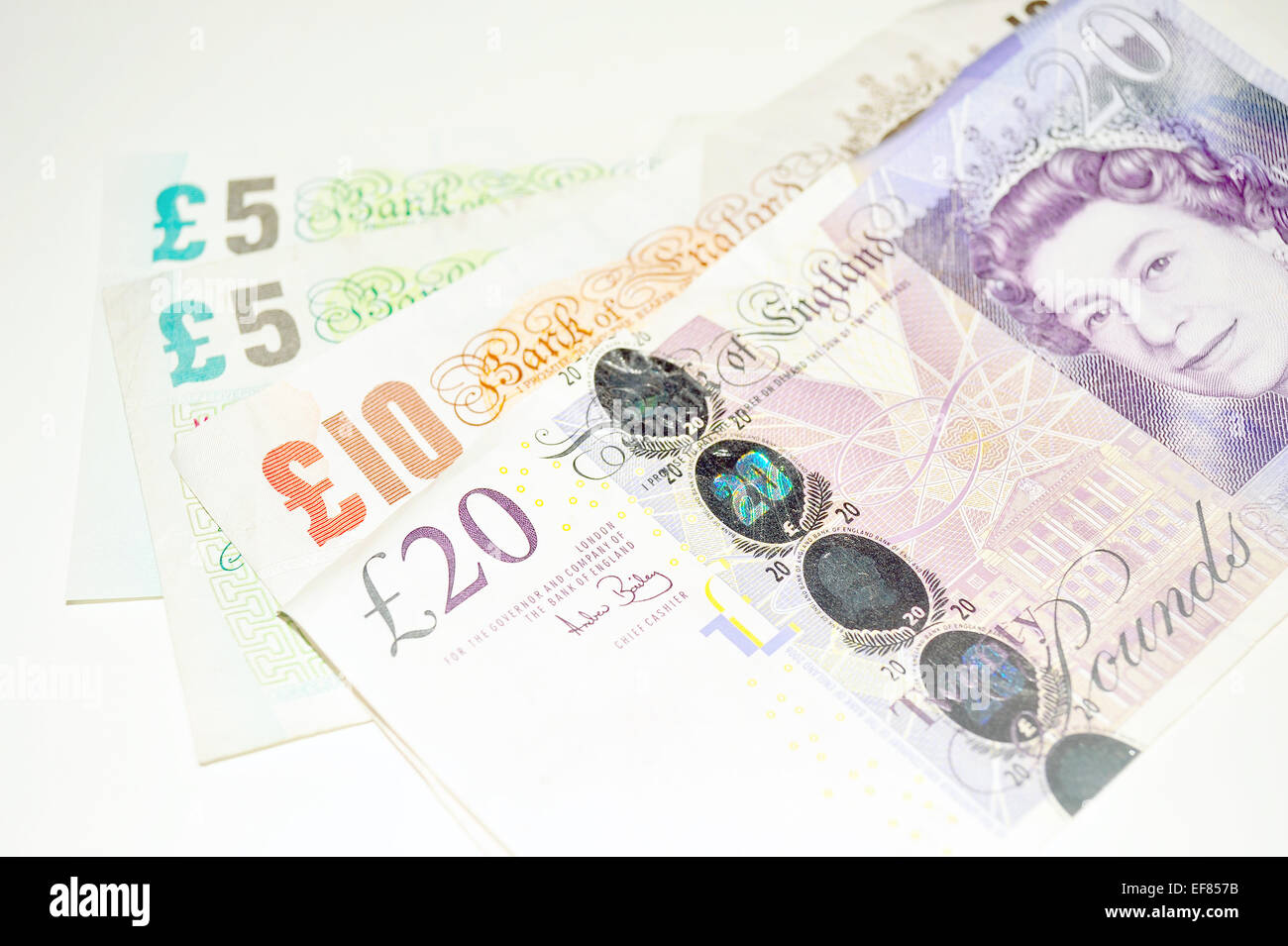 British £5, £10 and £20 currency notes photographed against a white ...