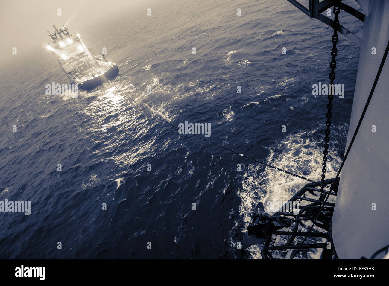 tug boat pulling chain in fog Stock Photo - Alamy