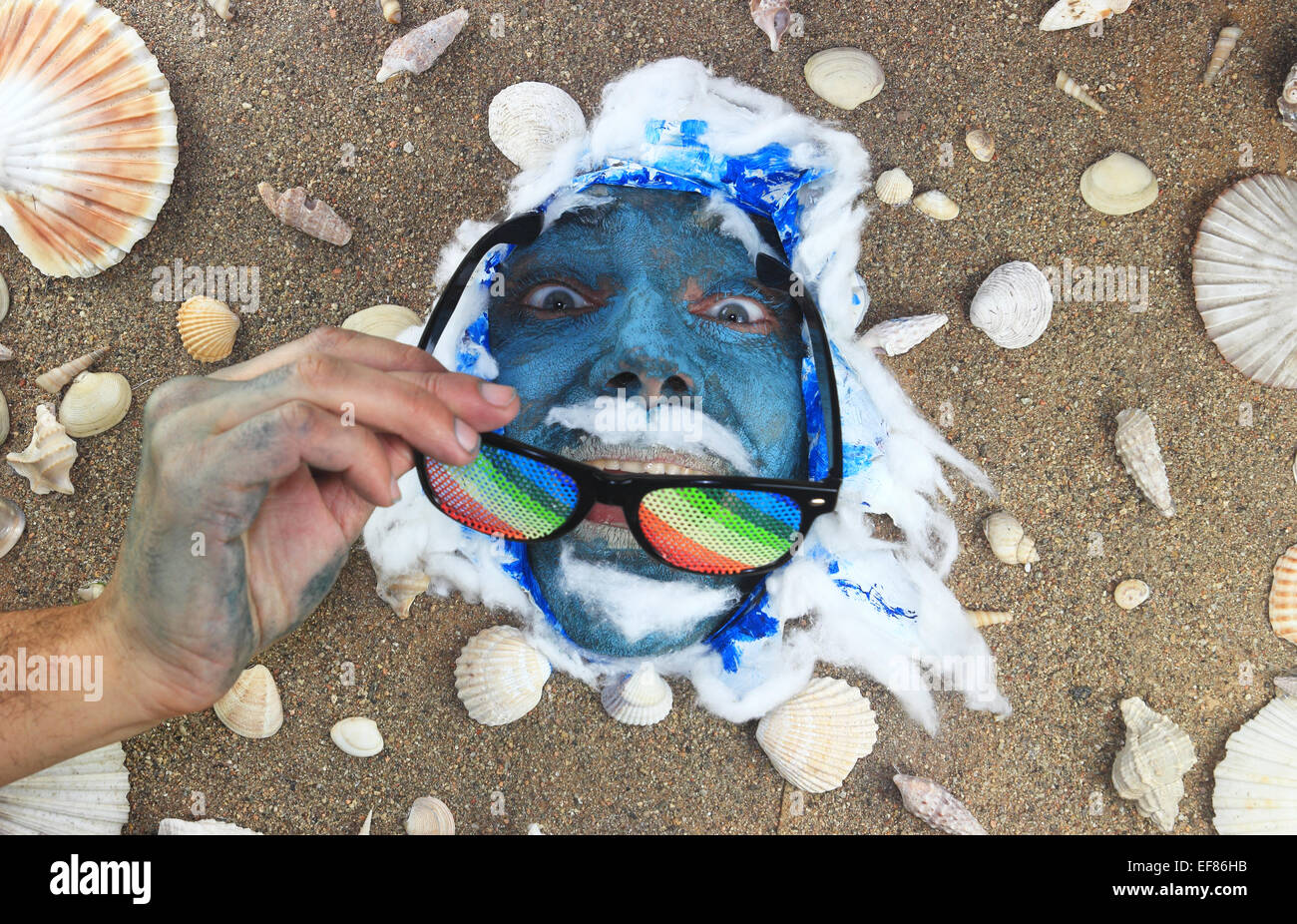 smiling man with colorful sunglasses under a bed of seashells Stock ...