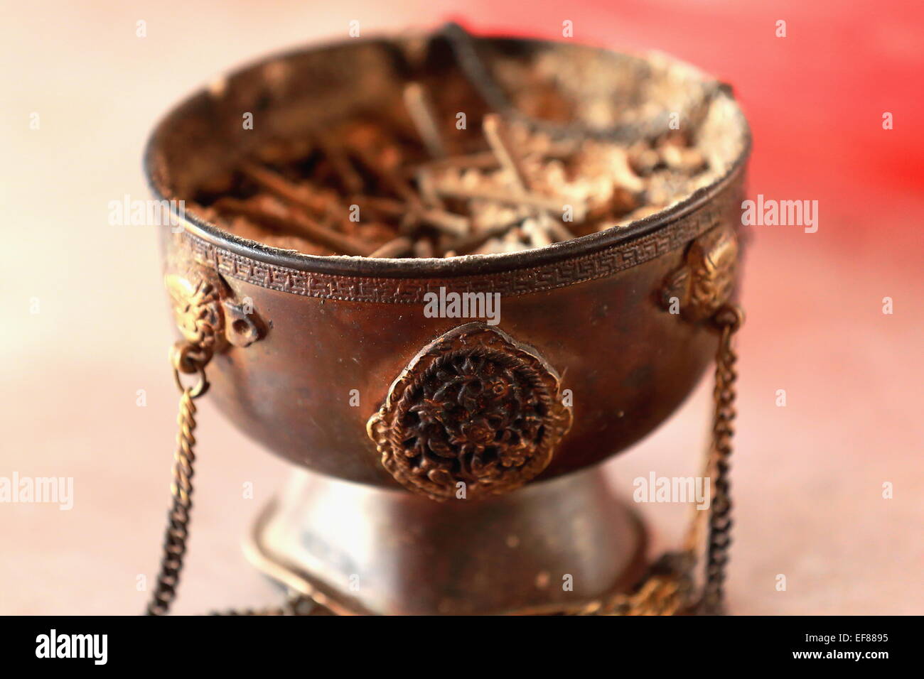 Ash filled bronze incensory with metallic chain and lotus flower relief ...