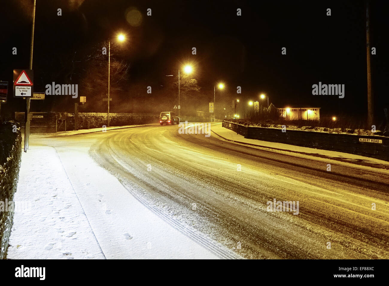 Blowing snow on roads in Queensbury, West Yorkshire at night Stock ...