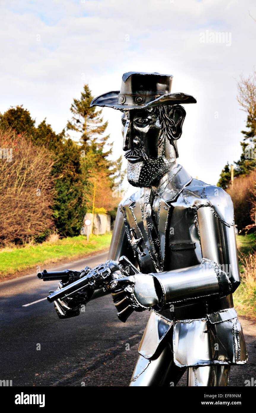 Life size Metal Cowboy sculpture with guns drawn on the roadside in ...