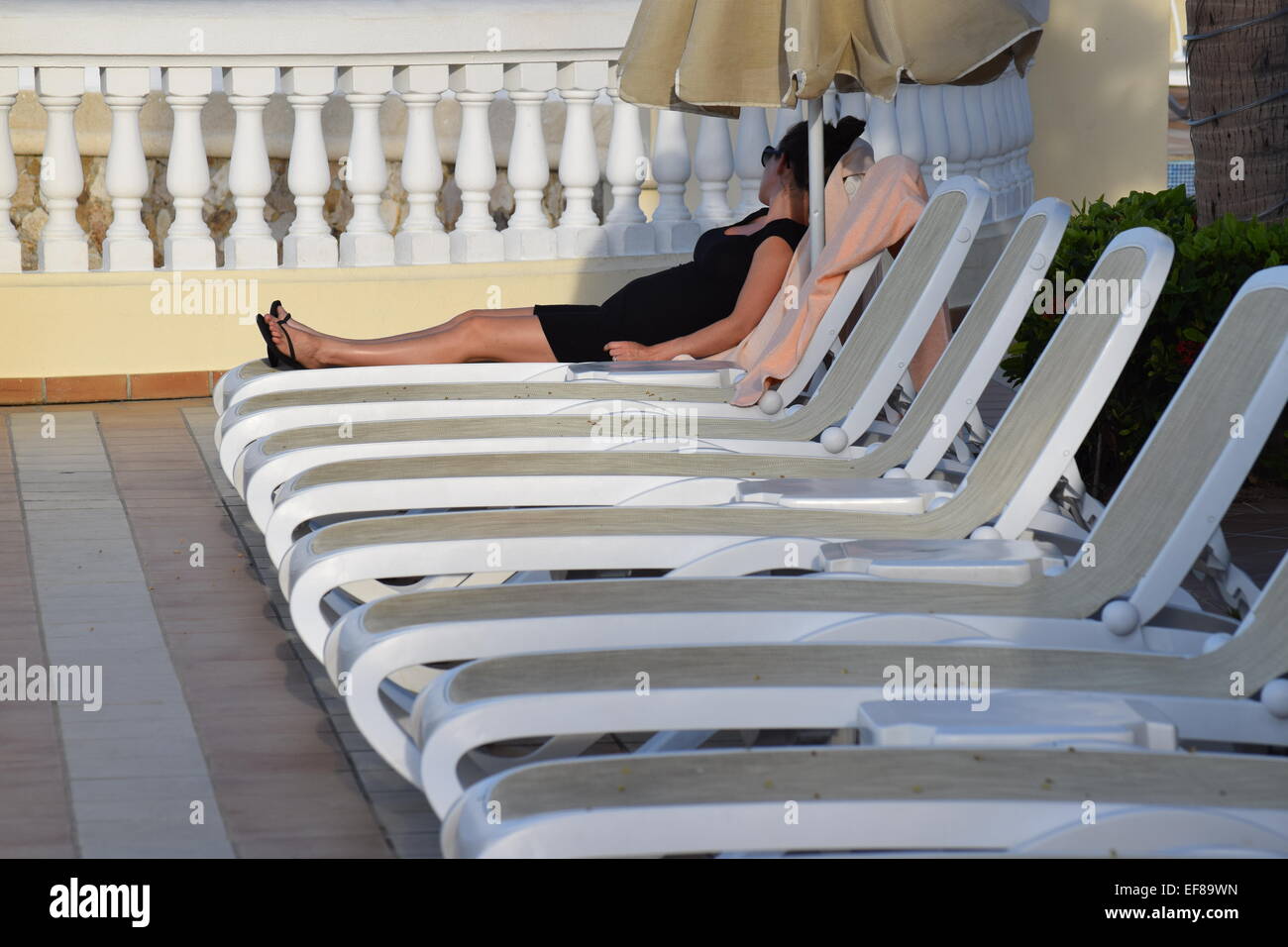 Woman lounging at Mexican resort Stock Photo - Alamy