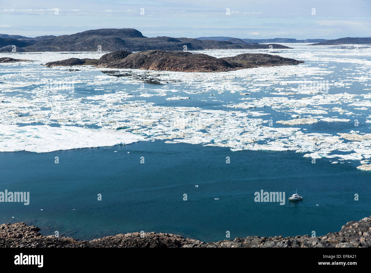 Canada, Nunavut Territory, C-Dory expedition boat surrounded by melting ...