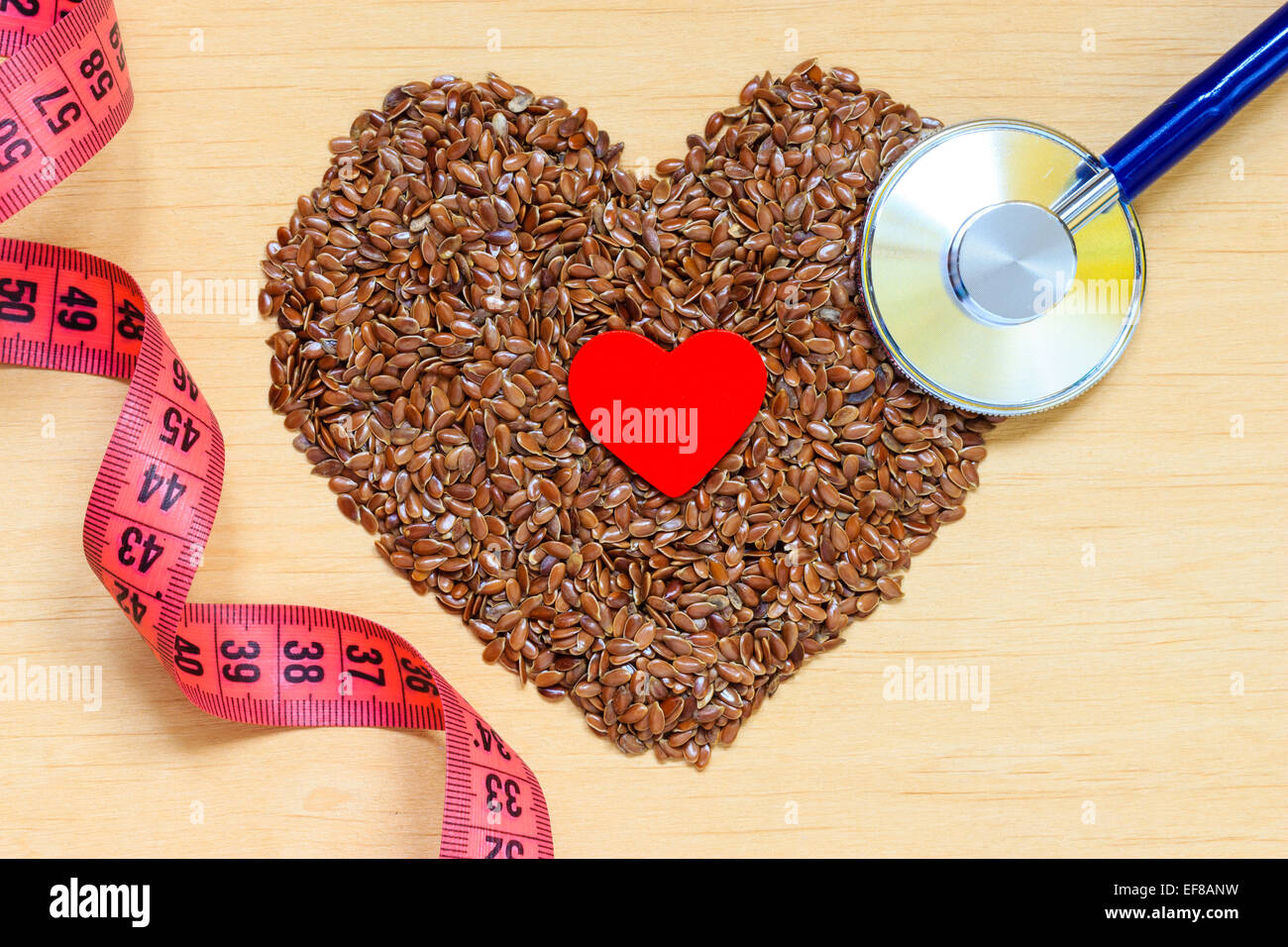 Diet healthcare weight reduction concept. Flax seeds linseed heart shaped stethoscope and ...