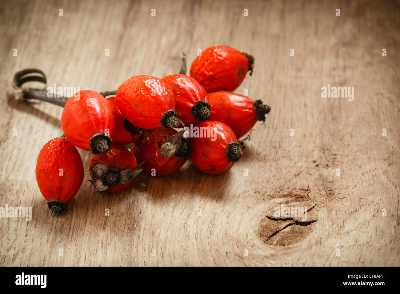 Hawthorn on wooden rustic table background. Rose hips haw fruit of the ...