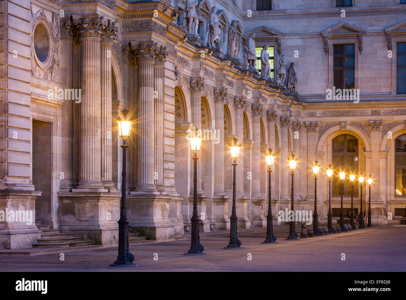Row of lamps in the courtyard of Musee du Louvre, Paris France Stock ...