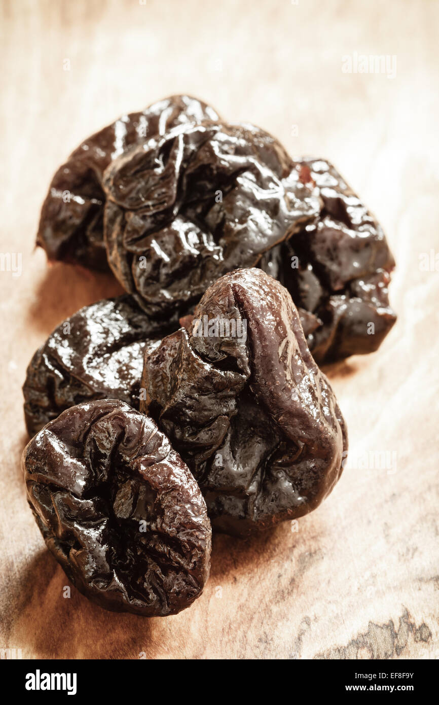 Healthy food, good cuisine. Closeup dried plums prunes fruits on wooden ...