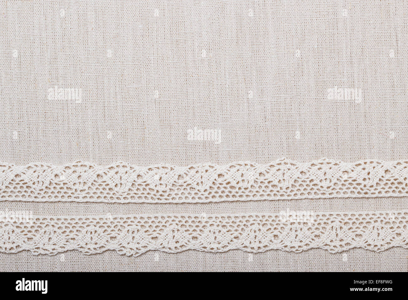 Lace ribbon on natural linen, bright cloth fabric background. Border ...