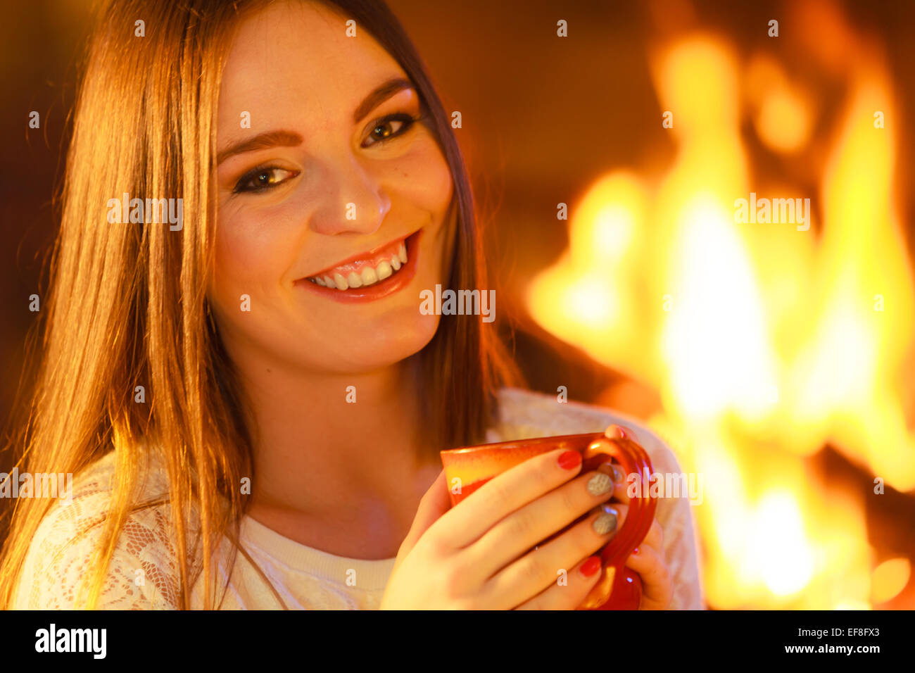 Winter at home, heating. Closeup woman face, smiling long hair girl ...