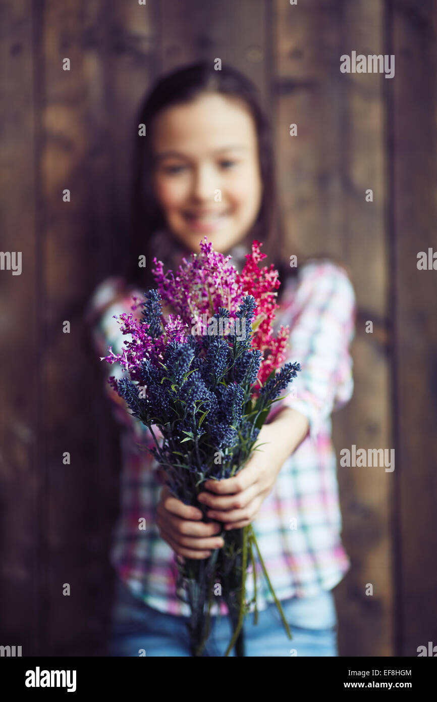 Little girl showing bunch of fresh wildflowers Stock Photo - Alamy