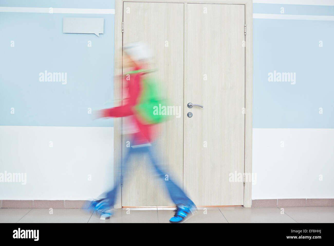 Schoolboy with backpack going fast by classroom door Stock Photo - Alamy