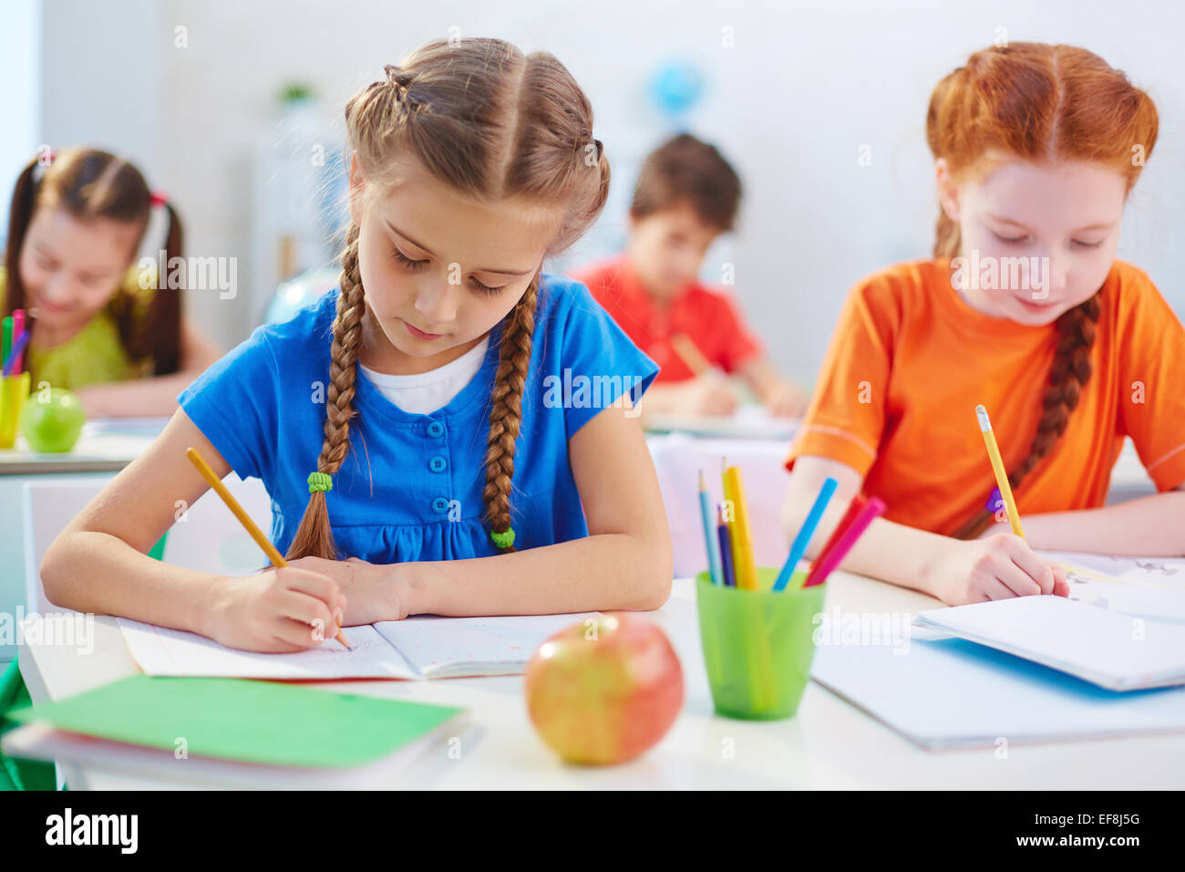 Clever schoolgirls drawing at lesson Stock Photo - Alamy