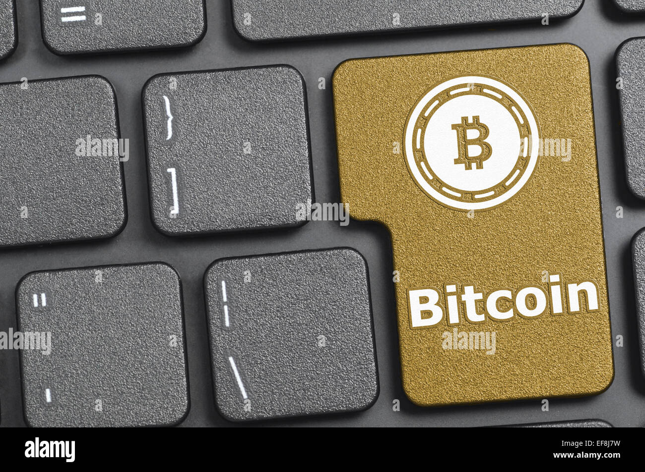 Golden bitcoin key on keyboard Stock Photo - Alamy