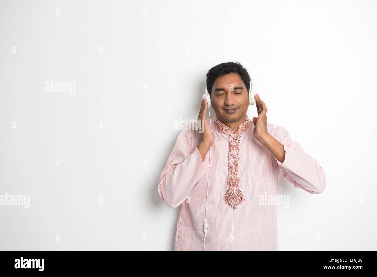 Traditional Young Indian Asian Male College Student listening music ...