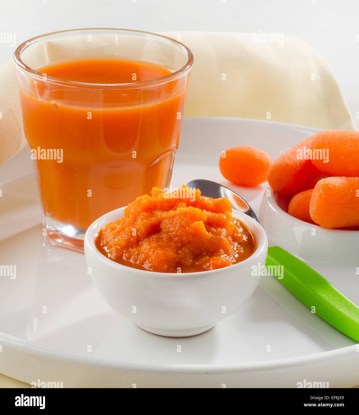Baby healthy food - pureed carrot and juice. Selective focus Stock ...