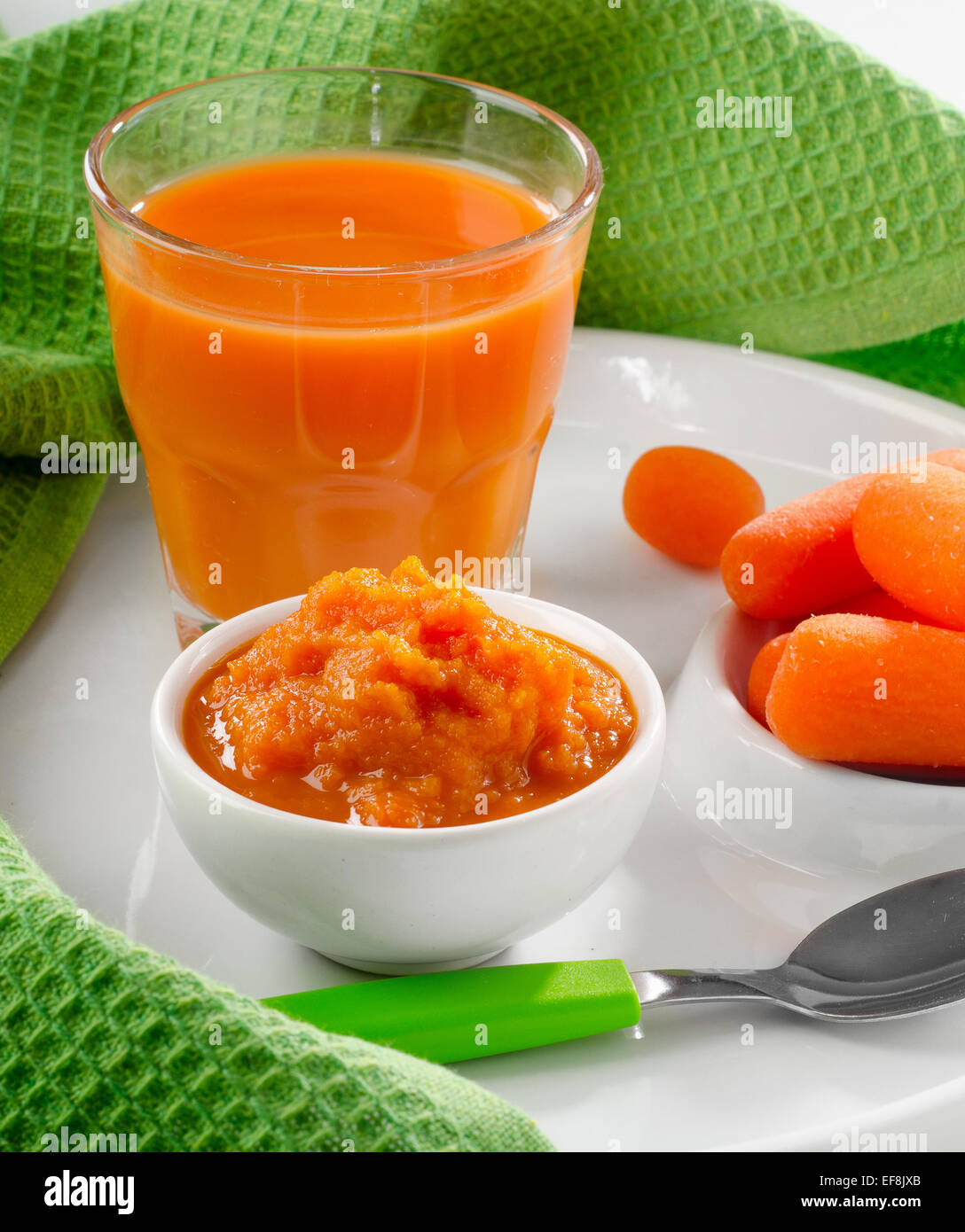 Baby healthy food - pureed carrot and juice. Selective focus Stock ...