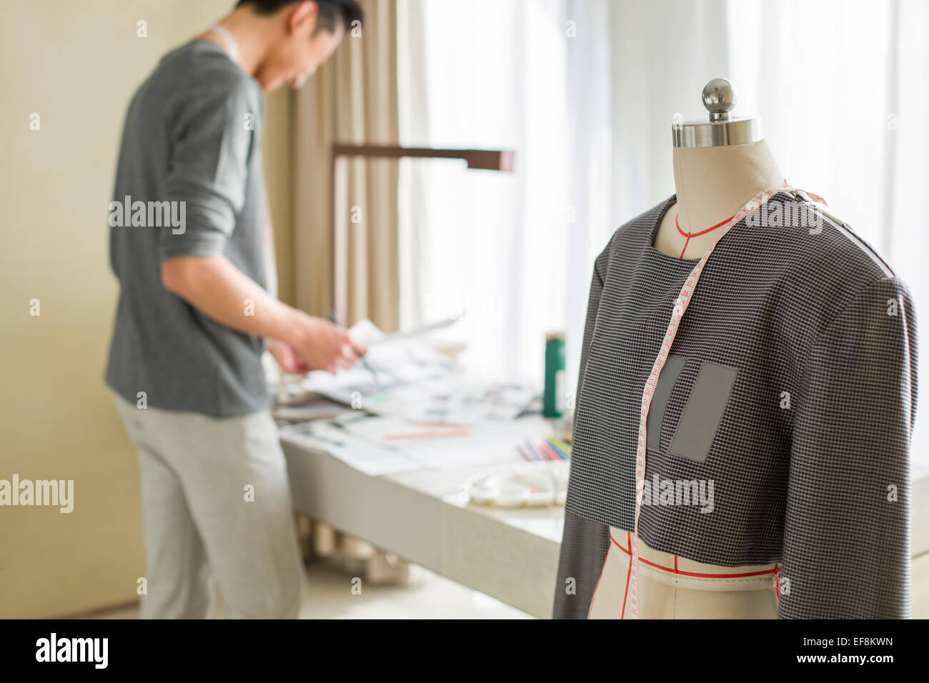 Fashion designer drawing sketch Stock Photo - Alamy