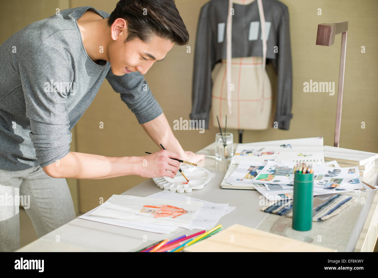 Fashion designer drawing sketch Stock Photo - Alamy