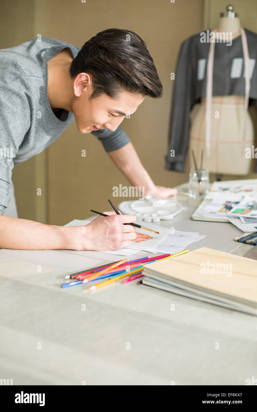 Fashion designer drawing sketch Stock Photo - Alamy