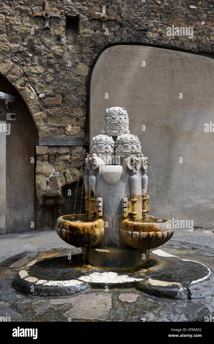 A water fountain with papal stone carving near St Peter's Square ...