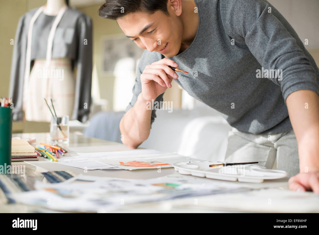 Fashion designer drawing sketch Stock Photo - Alamy