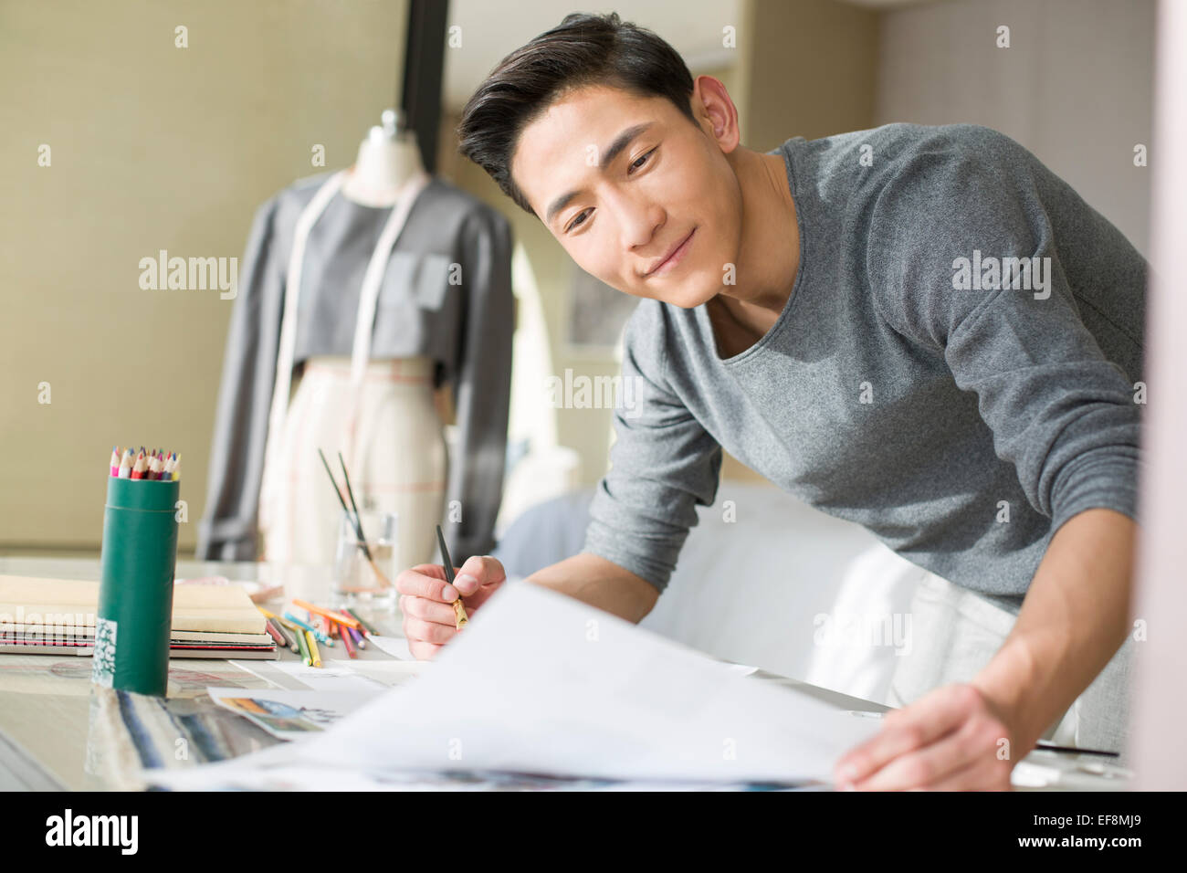 Fashion designer drawing sketch Stock Photo - Alamy