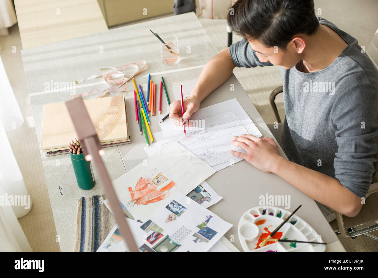 Fashion designer drawing sketch Stock Photo - Alamy