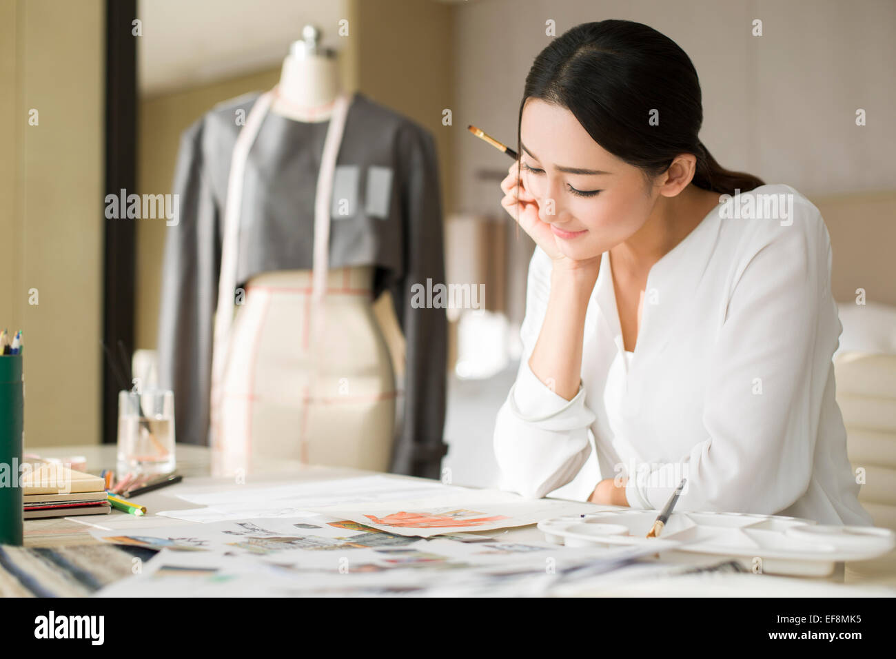 Fashion designer drawing sketch Stock Photo - Alamy