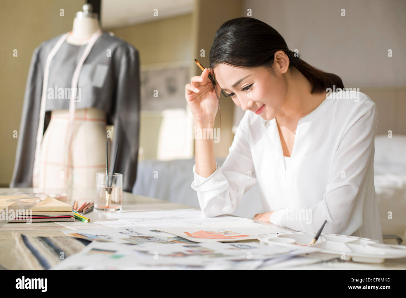 Fashion designer drawing sketch Stock Photo - Alamy