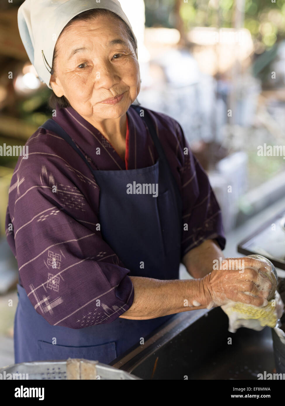 Kobashigawa Sumi (80) washing the dishes at Ryukyu Mura, Yomitan ...