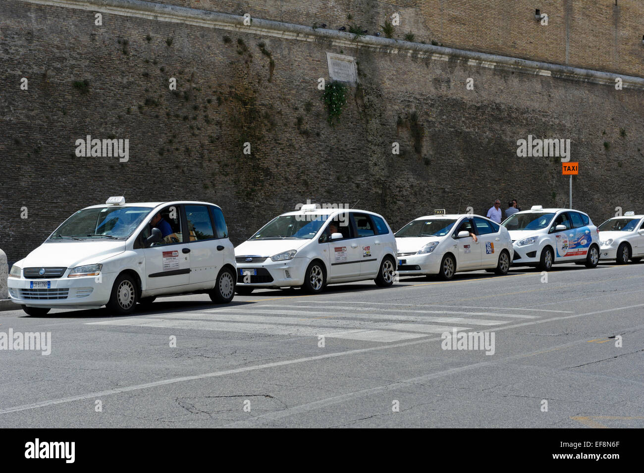 A Taxi stand with white taxi cars parked outside the Vatican Museum ...