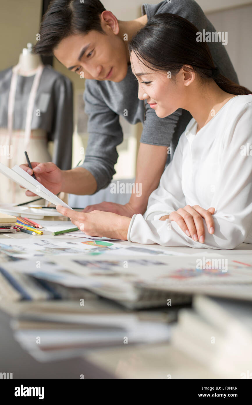 Two fashion designers drawing sketch Stock Photo - Alamy