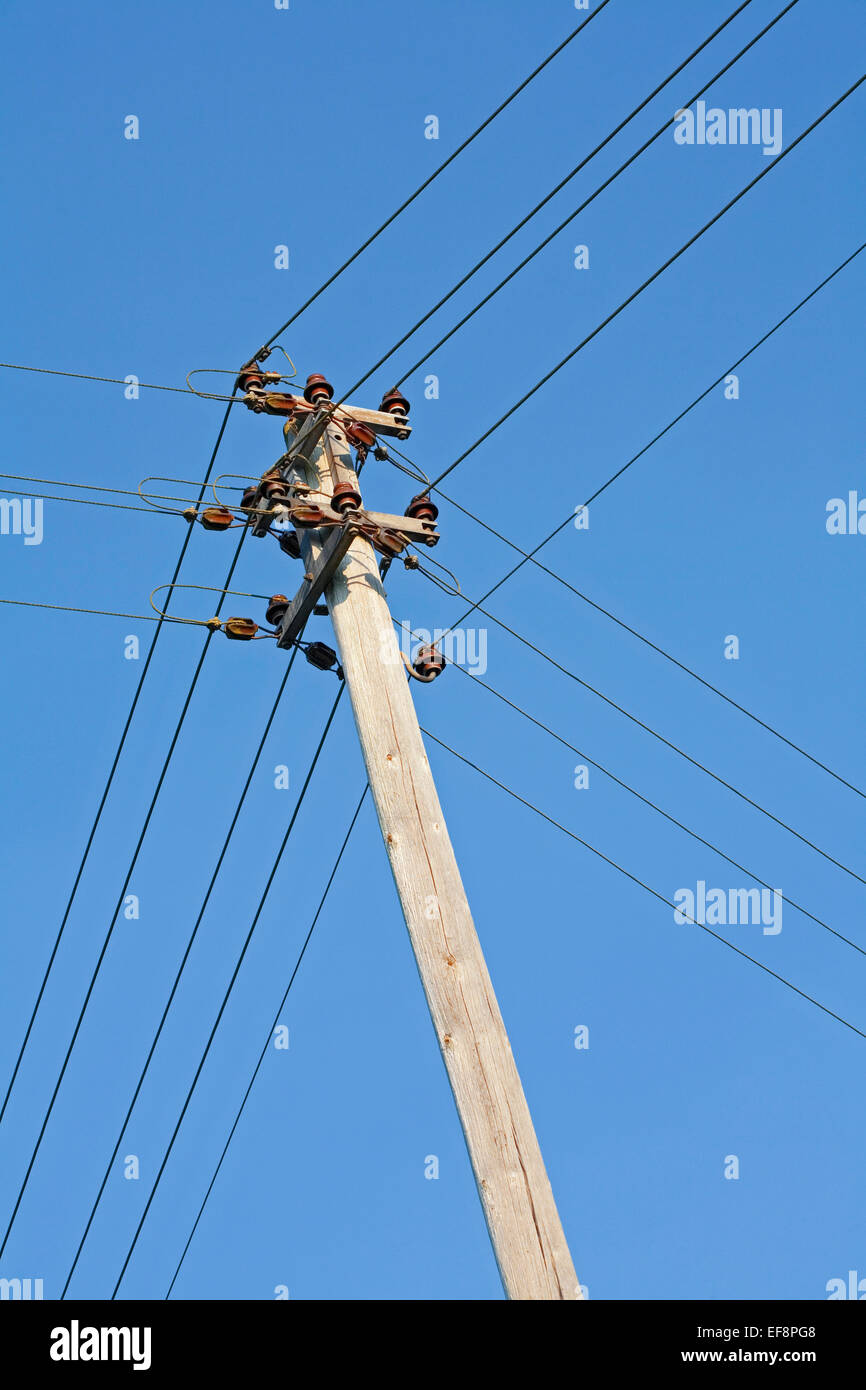 Electricity pylon with power lines and isolators against blue sky Stock ...