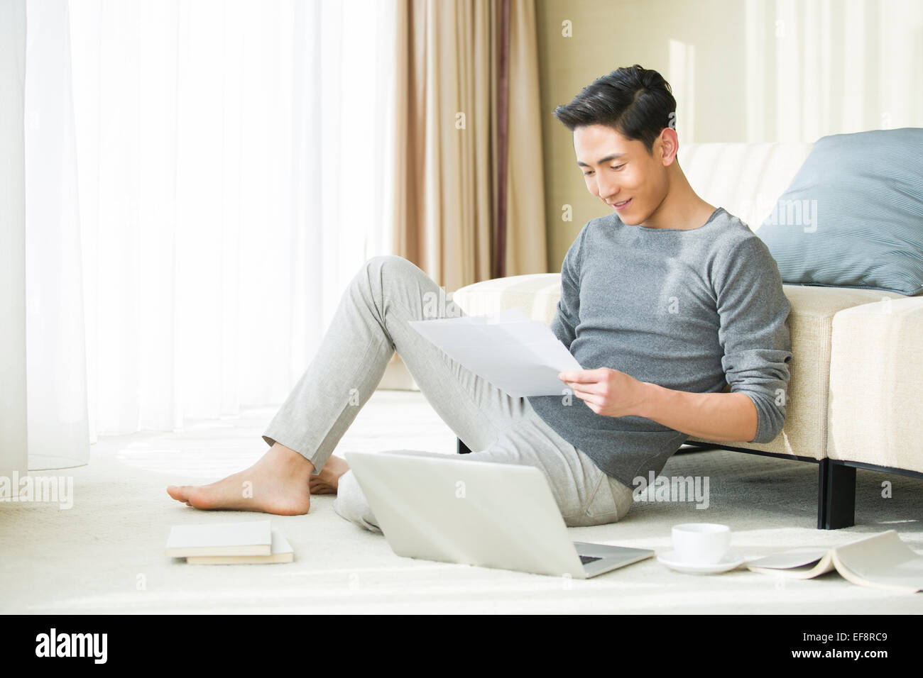 Young man working at home Stock Photo - Alamy