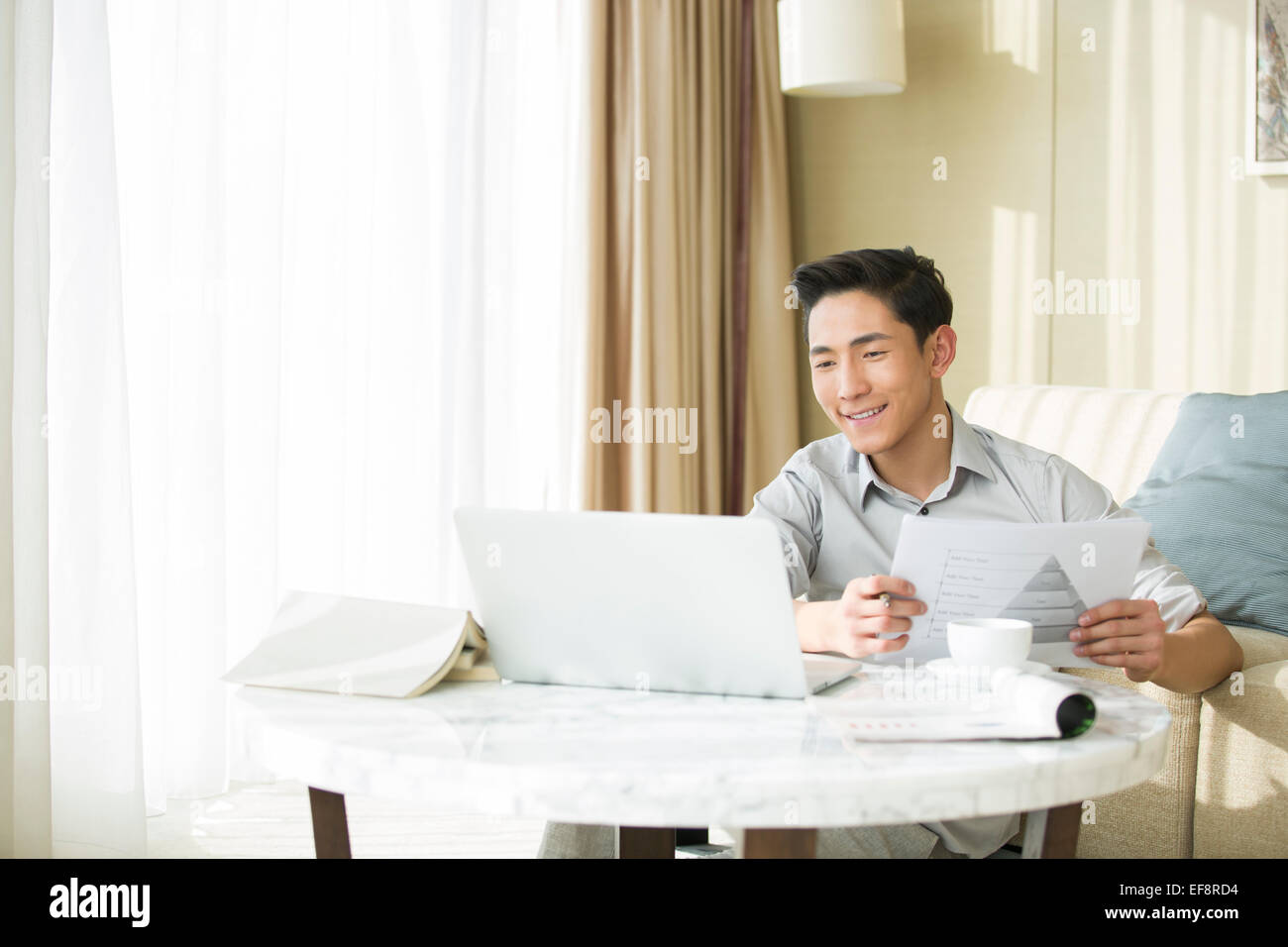 Young man working at home Stock Photo - Alamy