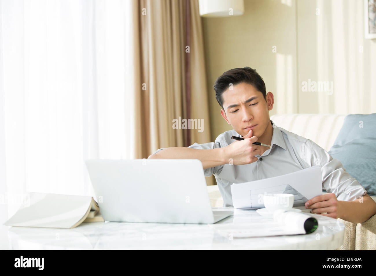 Young man working at home Stock Photo - Alamy