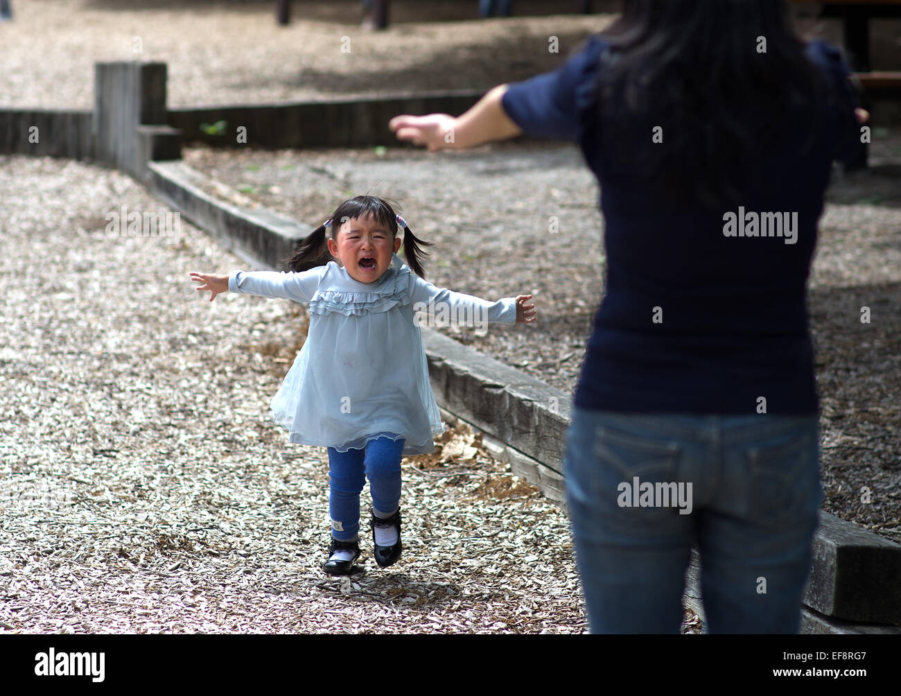 Australia, Melbourne, Crying girl running to mother Stock Photo - Alamy