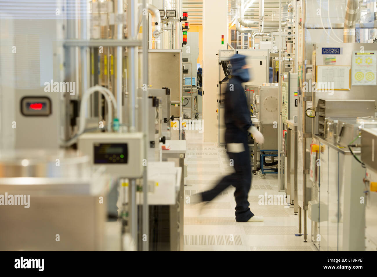 A staff member of semiconductor manufacturer Osram Opto, walks through ...