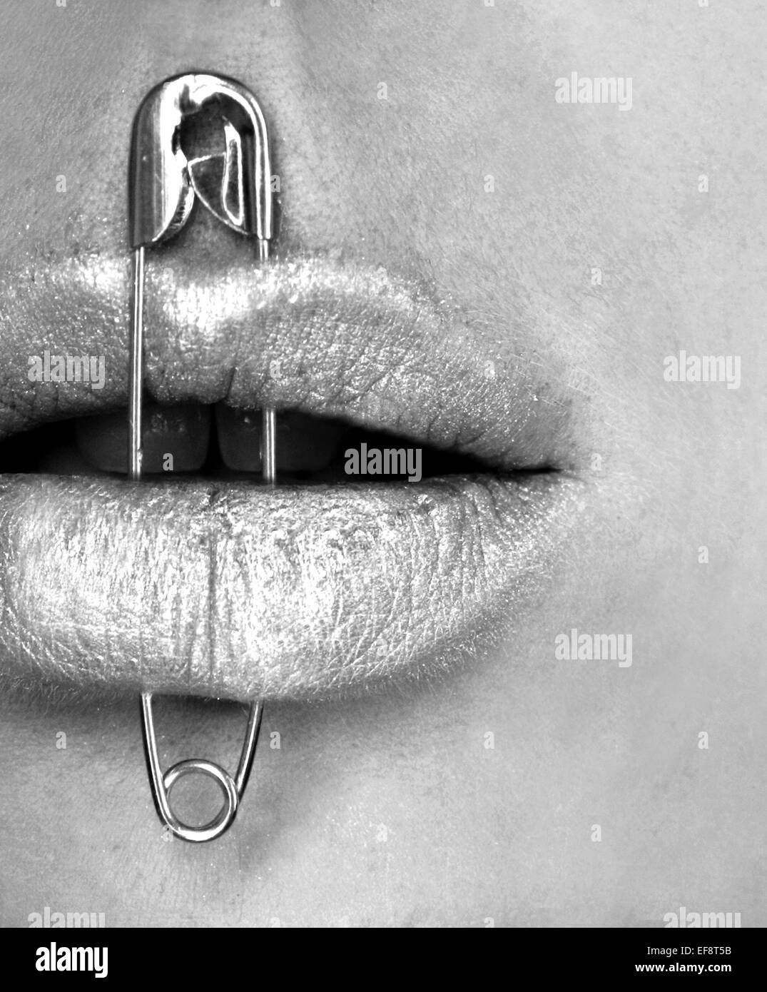 Safety pin through woman's lips Stock Photo - Alamy