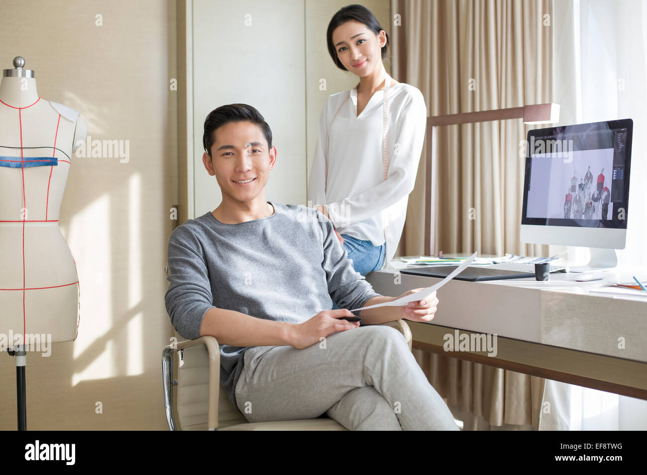 Young couple designing clothing together Stock Photo - Alamy