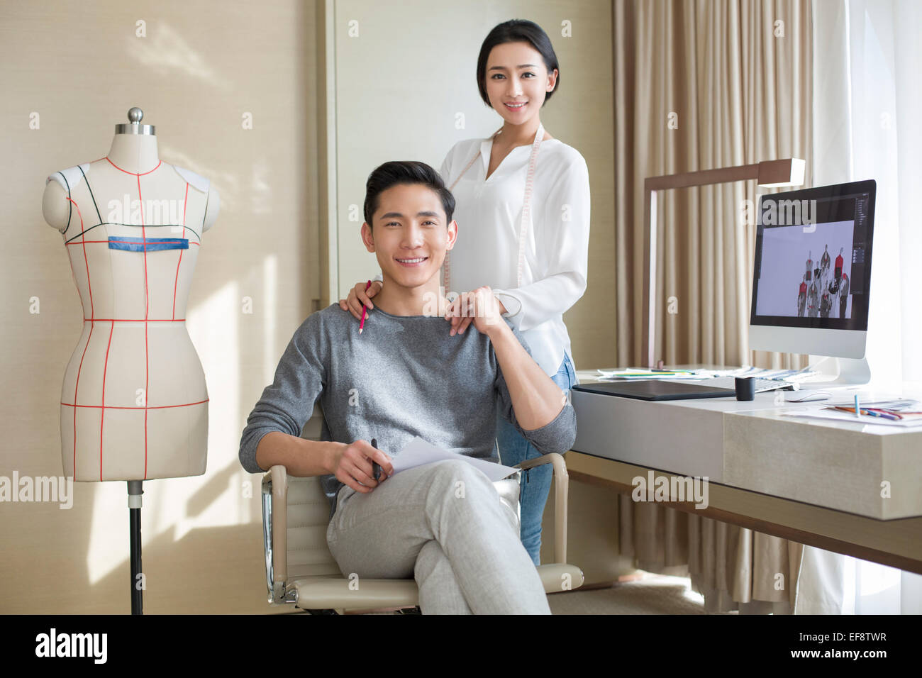 Young couple designing clothing together Stock Photo - Alamy