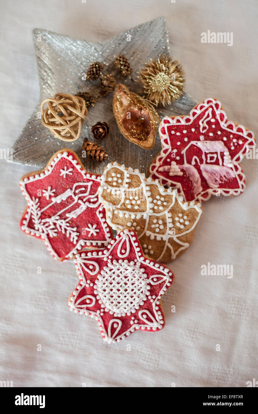 Overhead view of Christmas decorations and cookies on a tablecloth ...