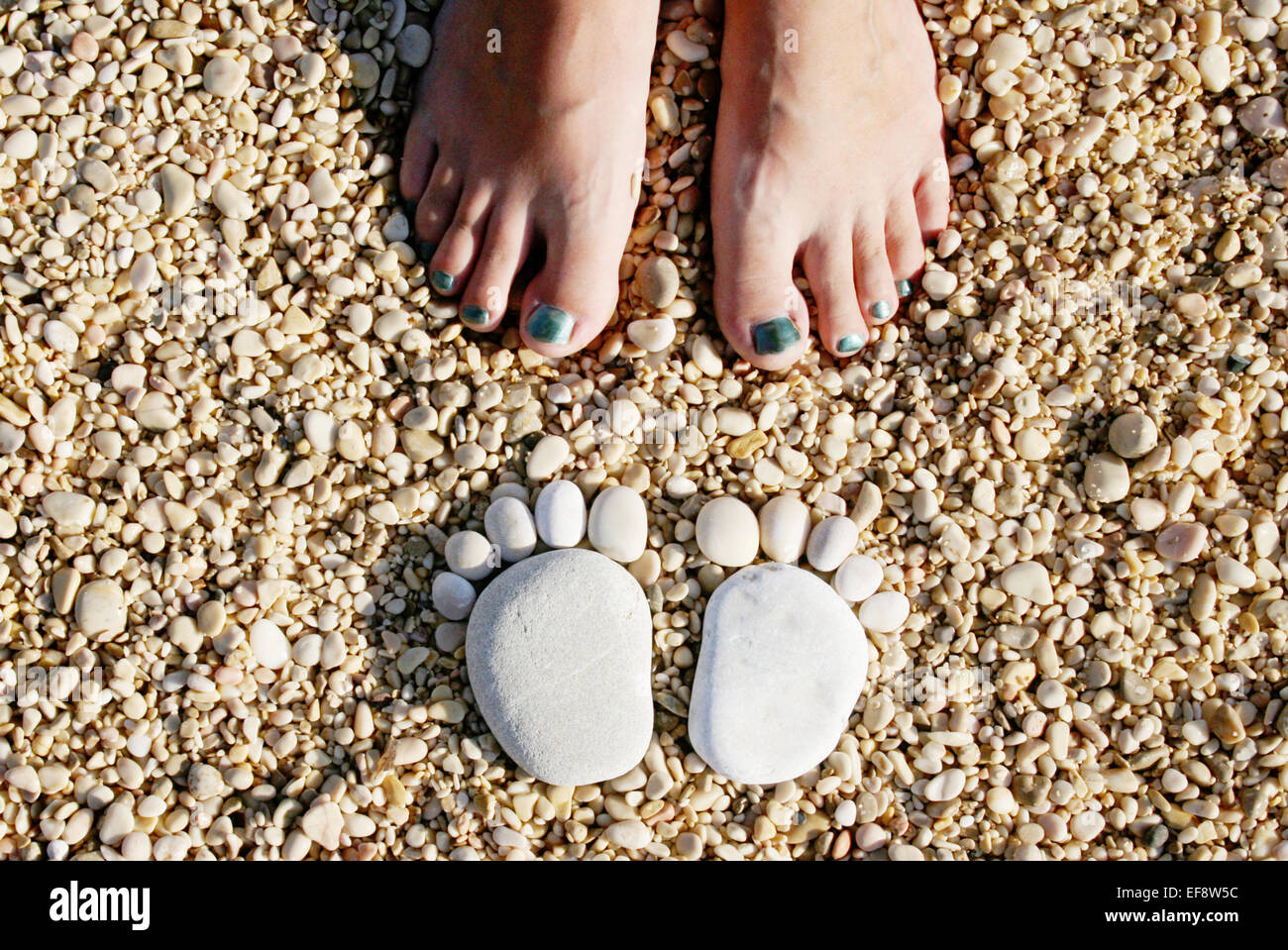 Stones in shape of feet in front of woman's feet, Stara Baska, Krk ...