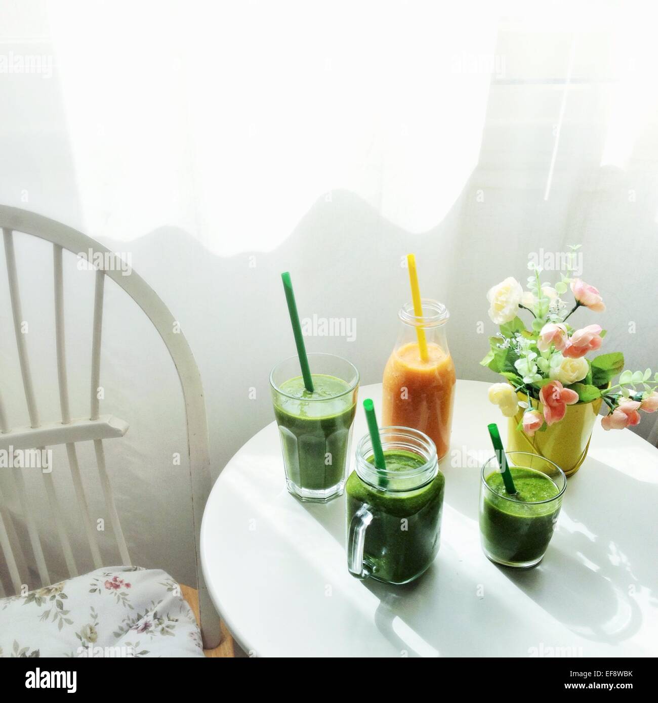 Green smoothies and carrot smoothies on table Stock Photo - Alamy